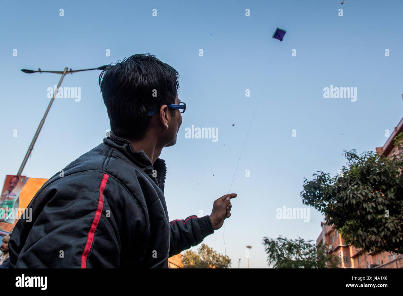 Indian man flying a kite in Jaipur, India Stock Photo - Alamy