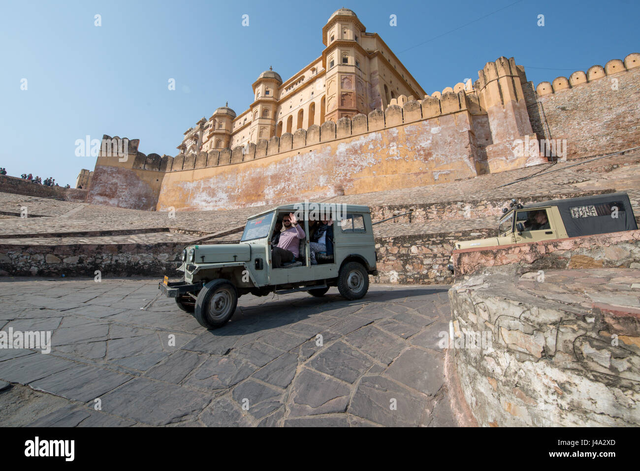 Man driving a Jeep passed the Amer Fort in Jaipur, India Stock Photo ...