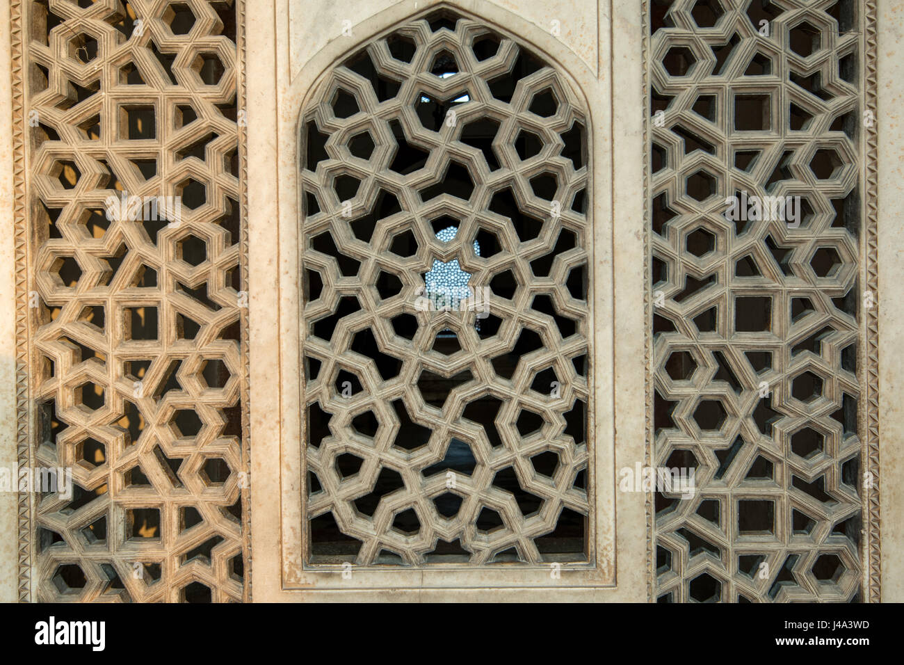 Jali stone, made with ornate geometry, is placed over a latticed screen ...