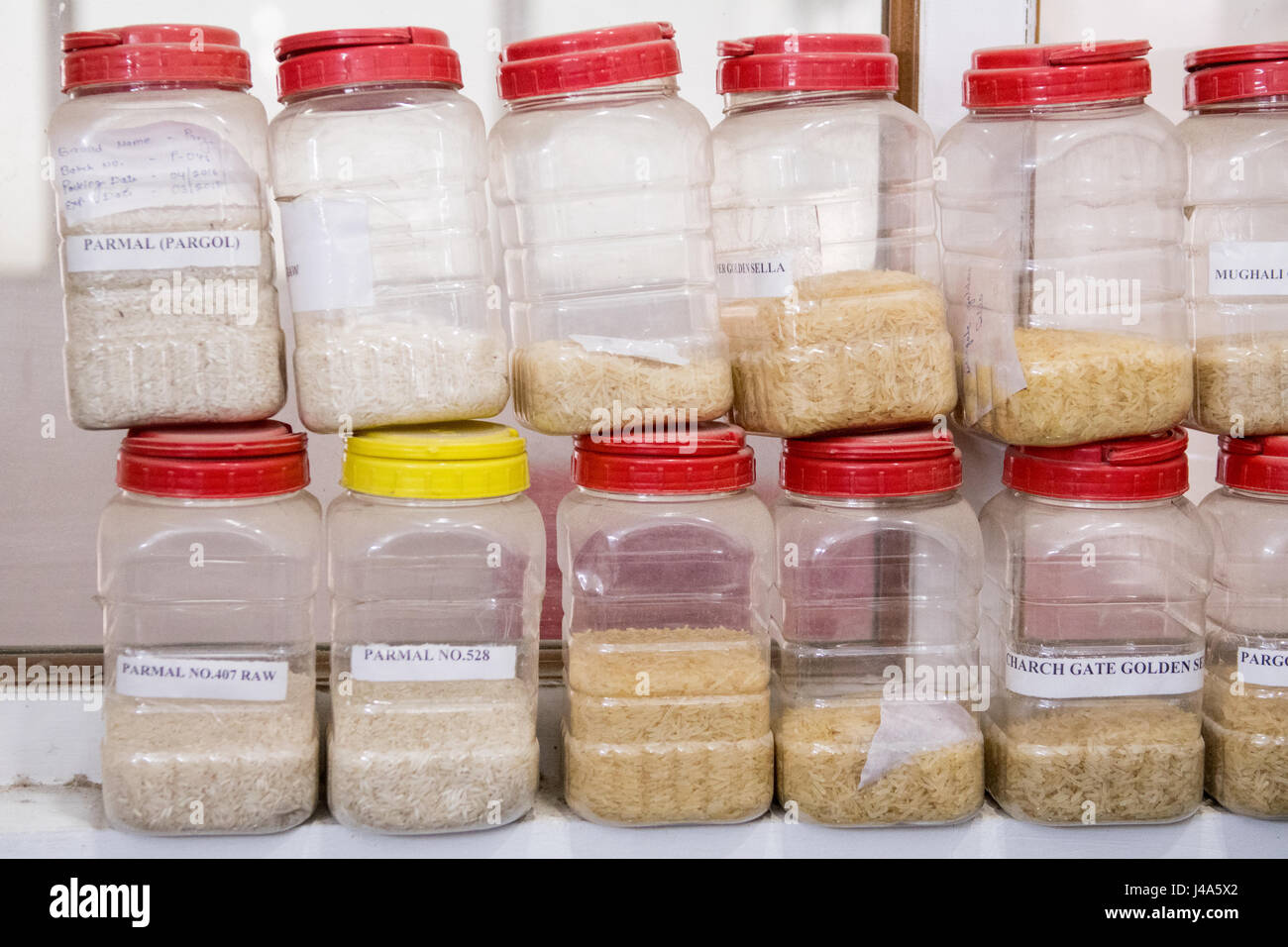 Variations of local rice and stored in plastic containers in New Delhi ...