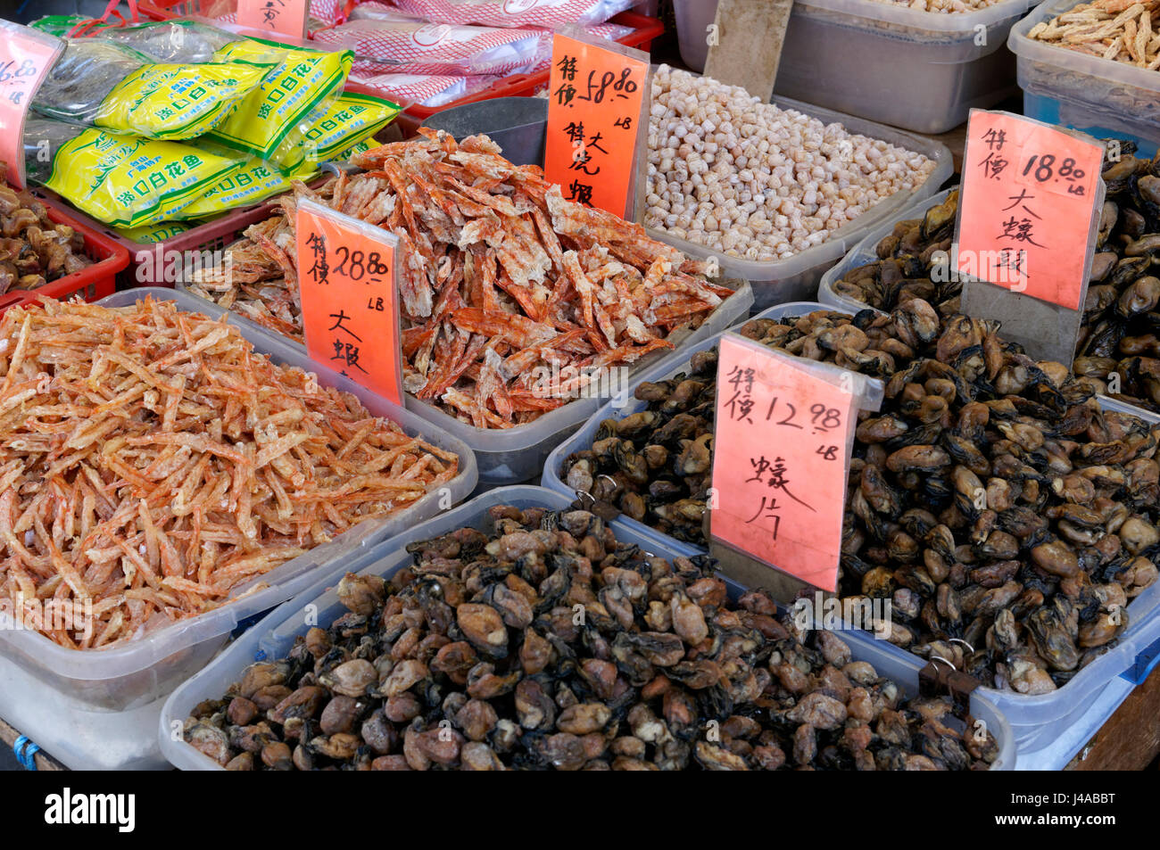 Bins and jars of traditional Chinese dried food and herbs in a shop in ...