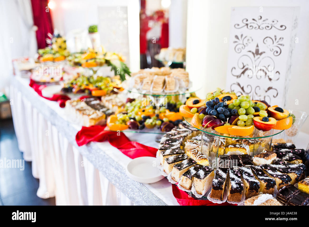 Wedding reception catering table with different fruits and cakes Stock ...
