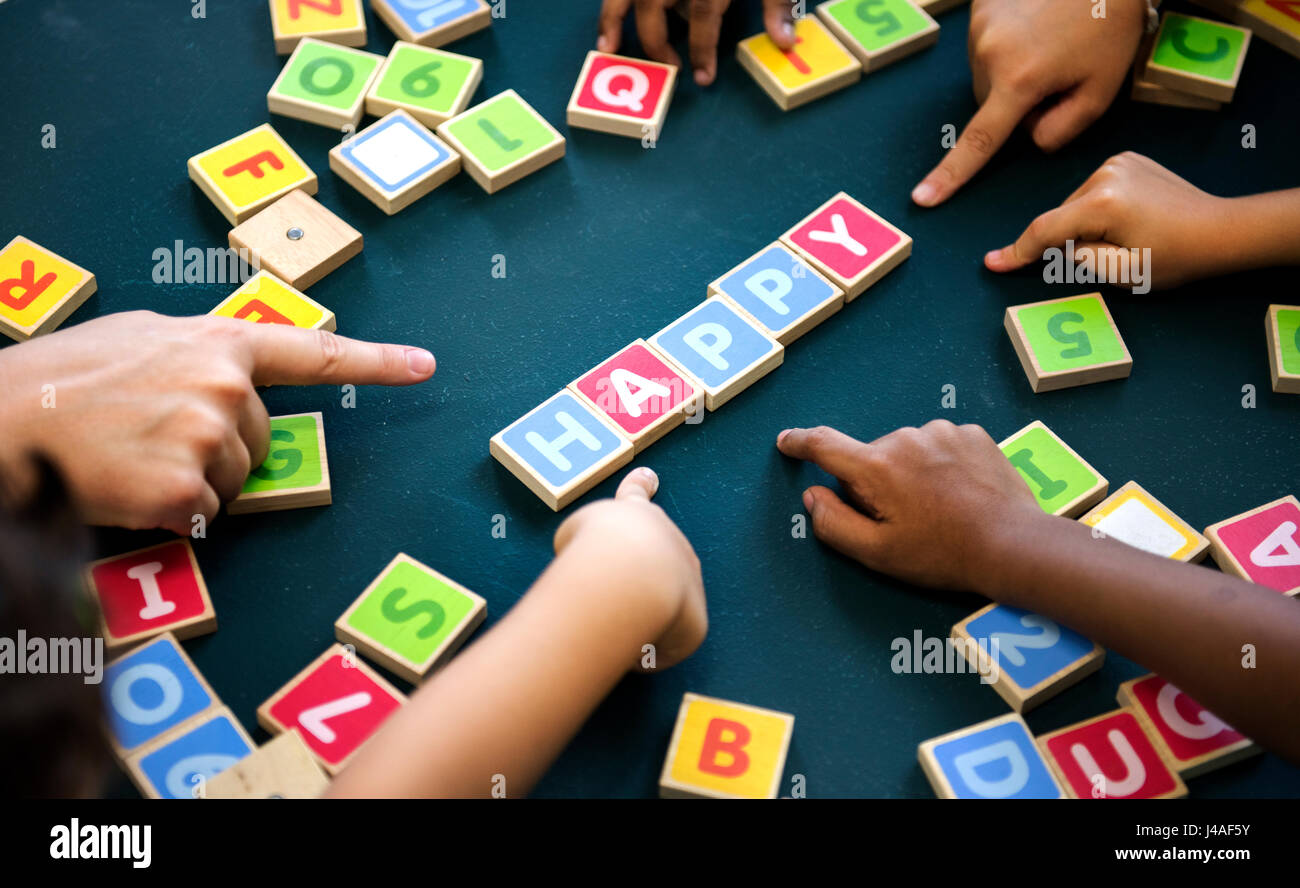 Kindergarten kids playing wooden alphabets letters vocabulary game ...