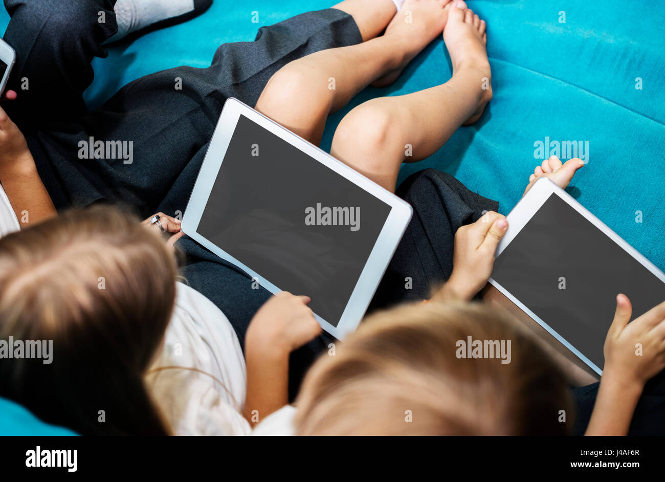 Group of diverse kindergarten students using tablet Stock Photo - Alamy