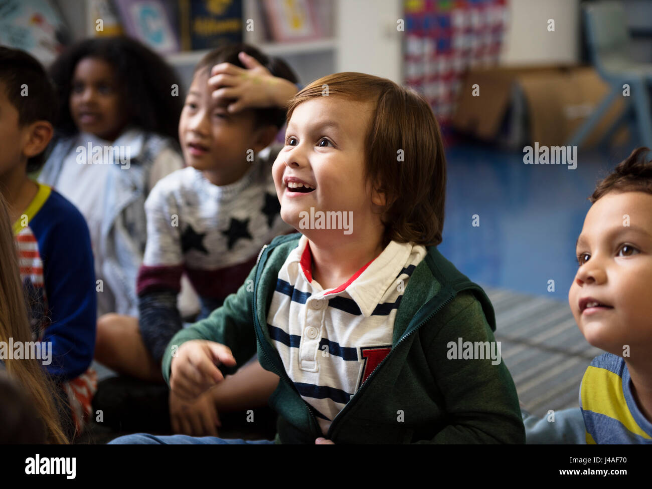 Kindergarten students sitting on the floor Stock Photo - Alamy