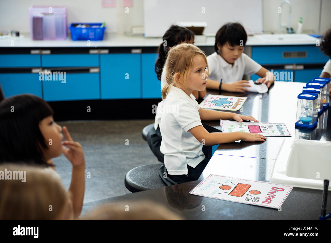 Diverse kindergarten students learning study in classroom Stock Photo ...