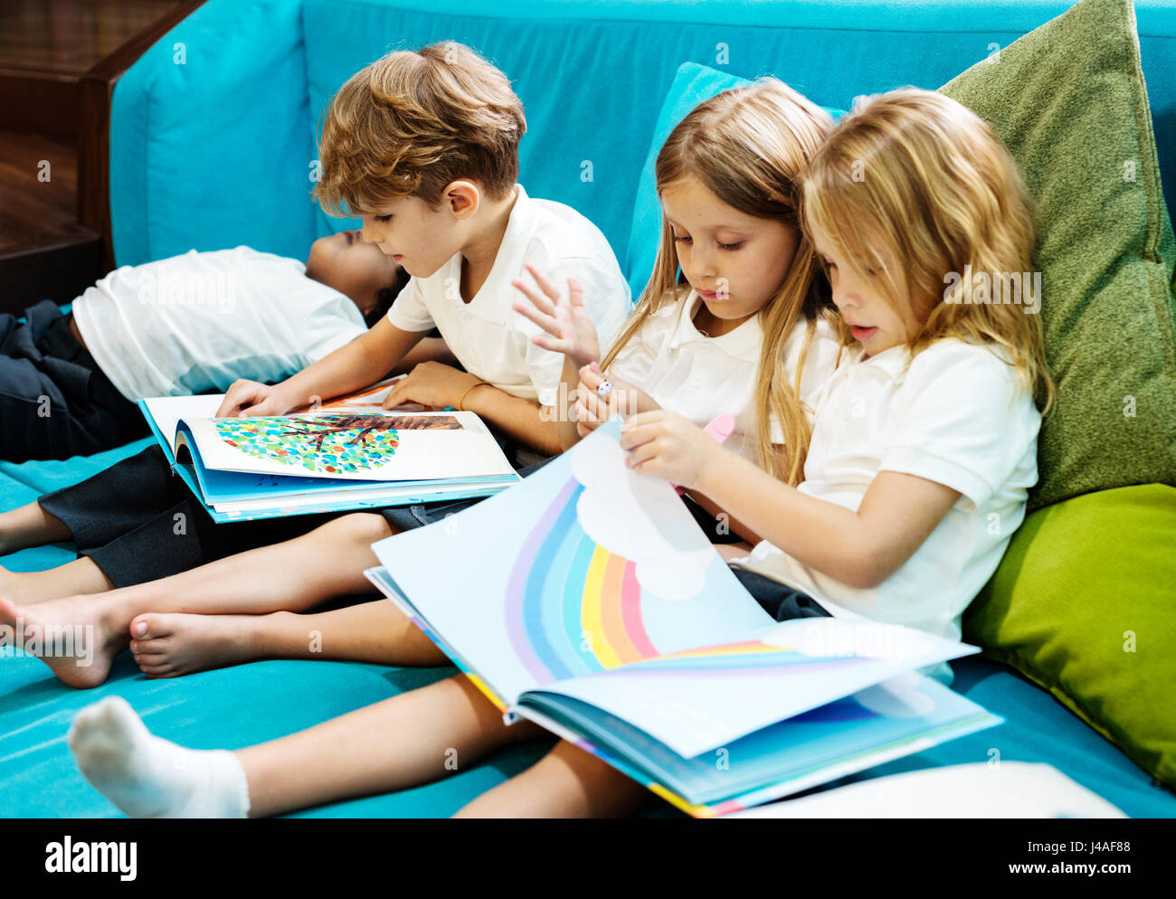 Group of Diverse Young Students Reading Children Story Book Together ...