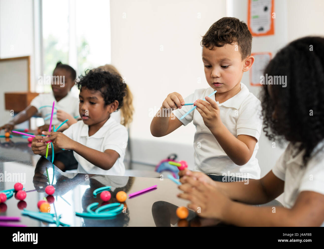 Kindergarten students holding learning structures from toys Stock Photo ...
