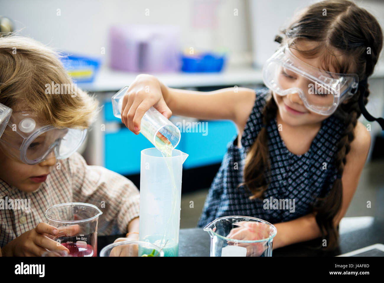 Kindergarten Students Mixing Solution in Science Experiment Laboratory ...