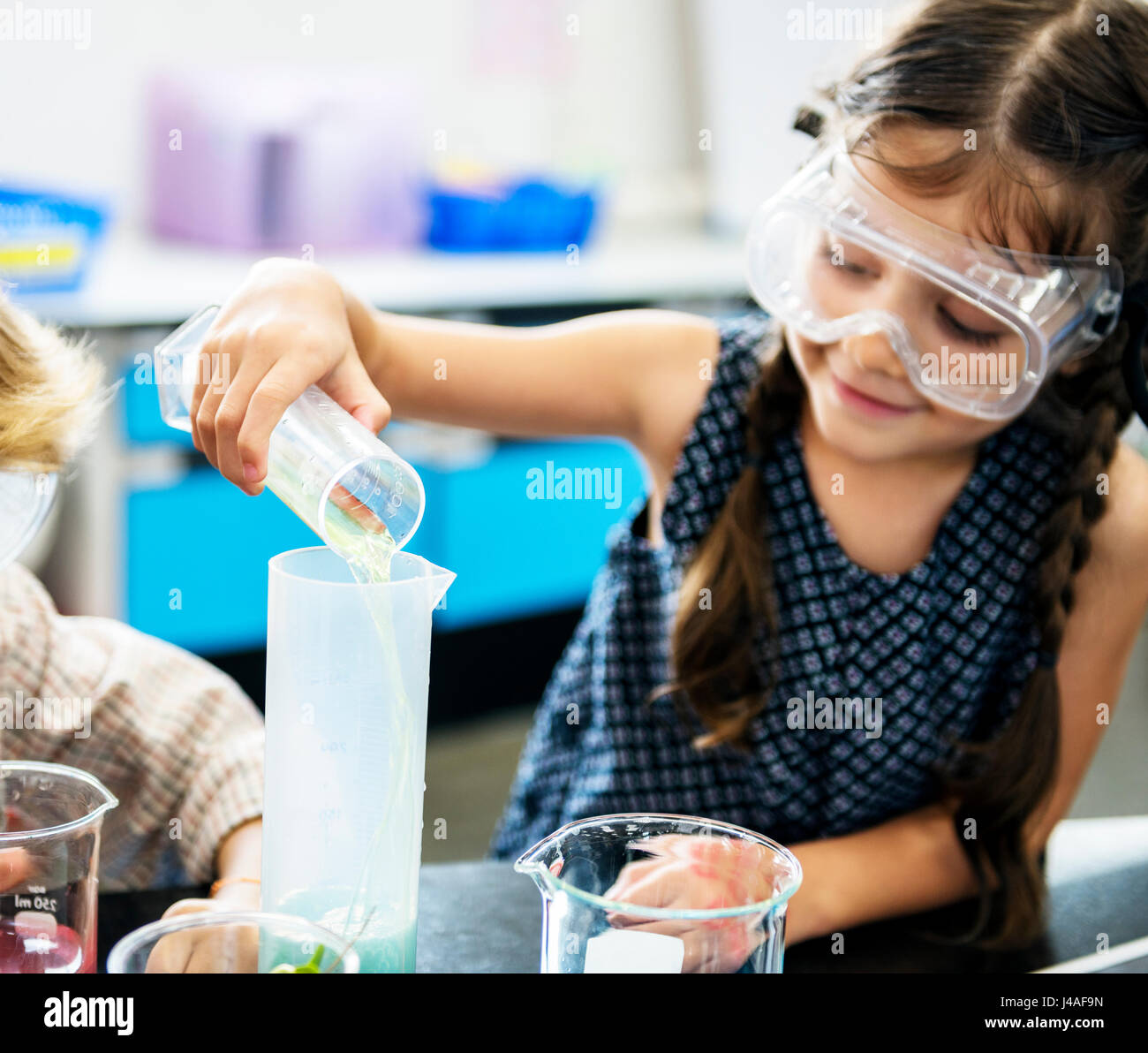 Kindergarten Students Mixing Solution in Science Experiment Laboratory ...