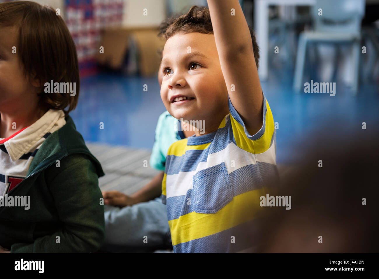 Kindergarten students sitting on the floor Stock Photo - Alamy