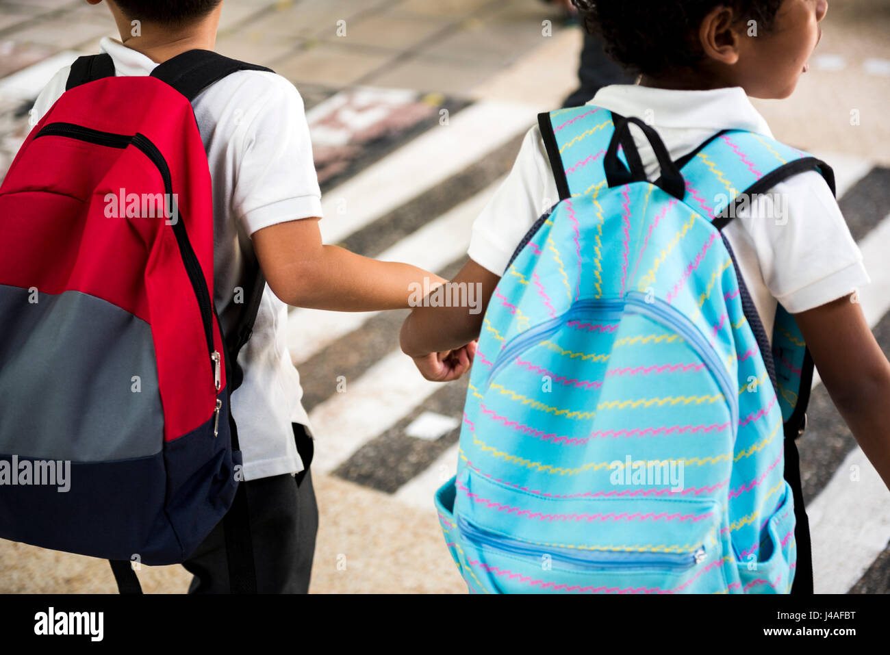 Kindergarten students walking crossing school road Stock Photo - Alamy