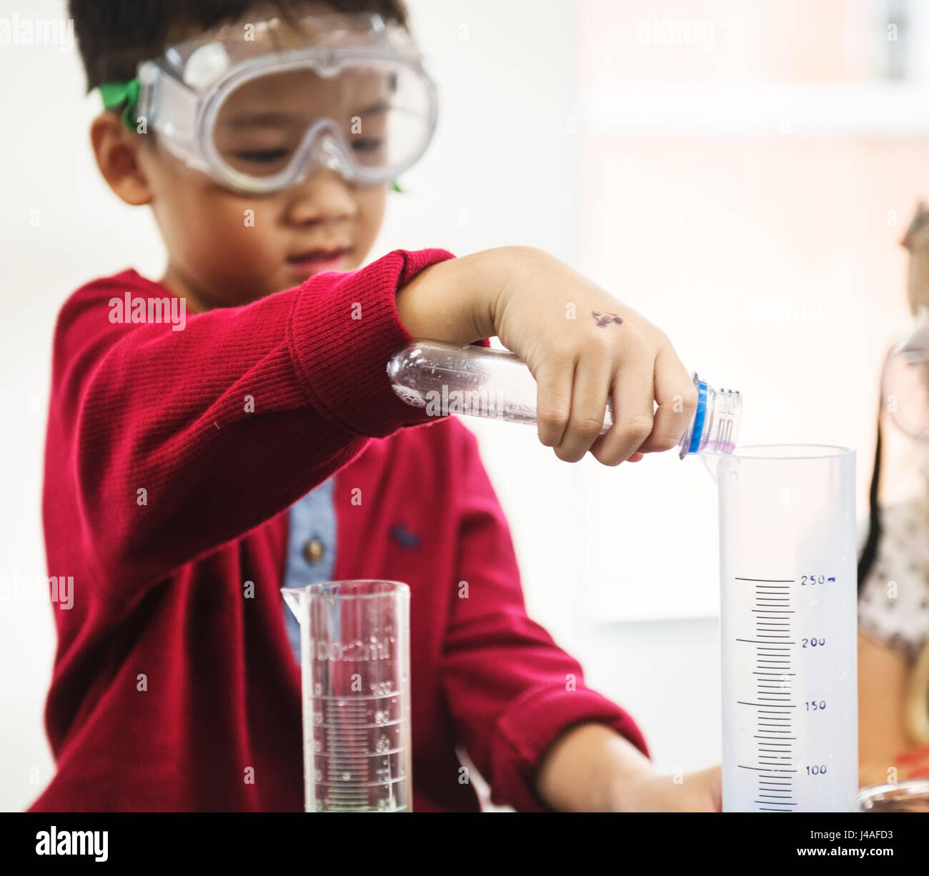 Kindergarten Student Mixing Solution in Science Experiment Laboratory ...