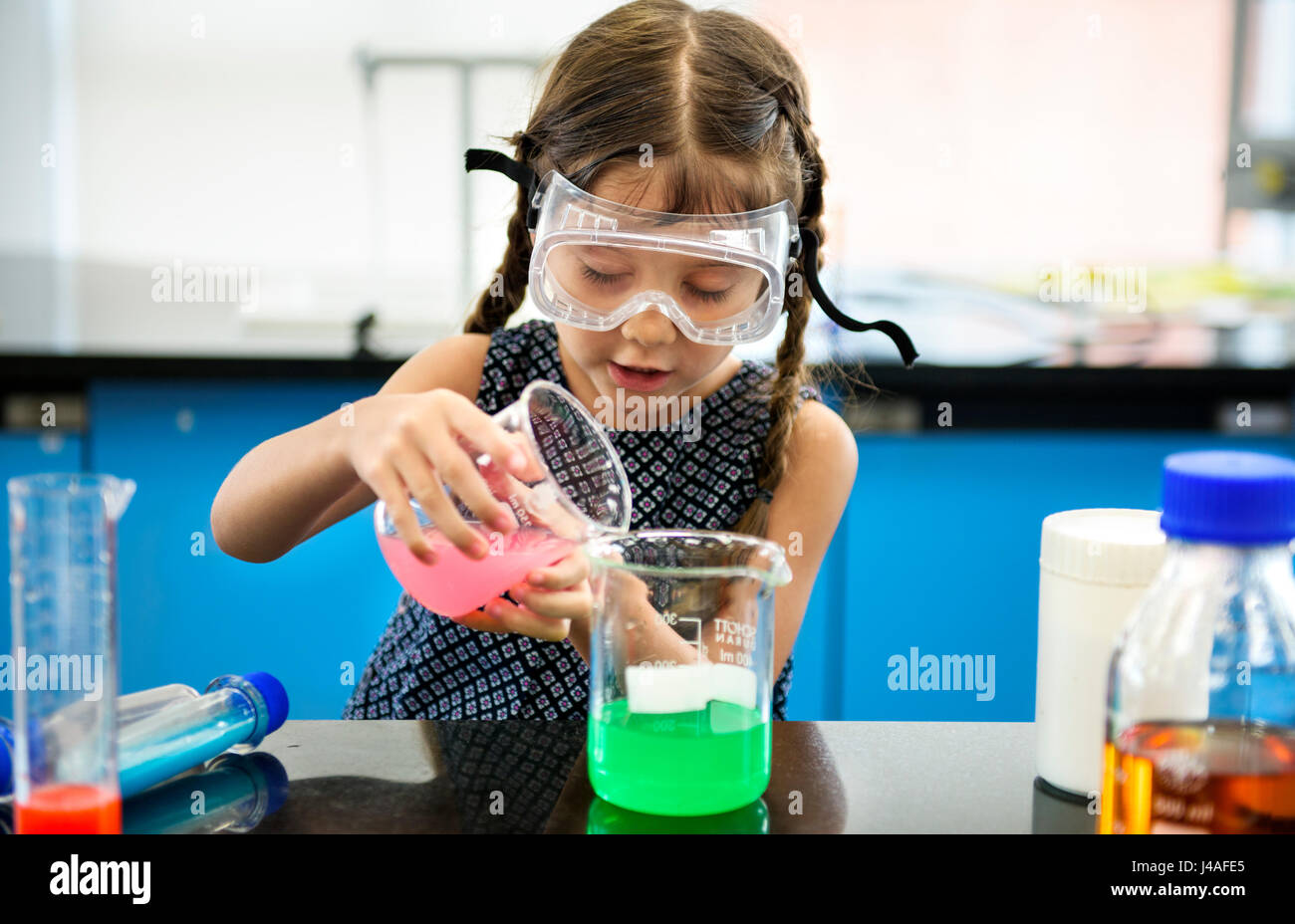 Kindergarten Student Mixing Solution in Science Experiment Laboratory ...