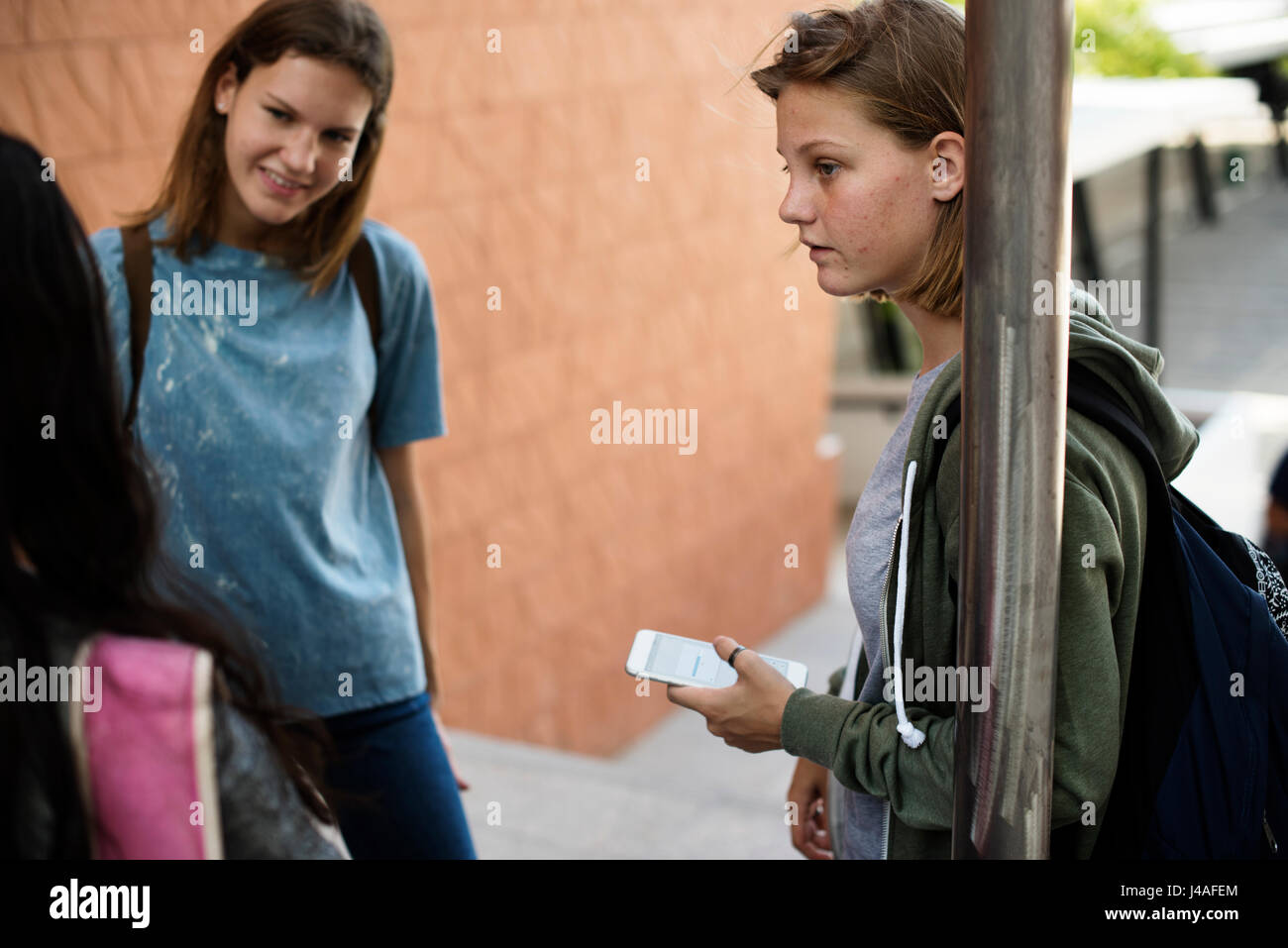 Girls friends talking together on staircase Stock Photo - Alamy