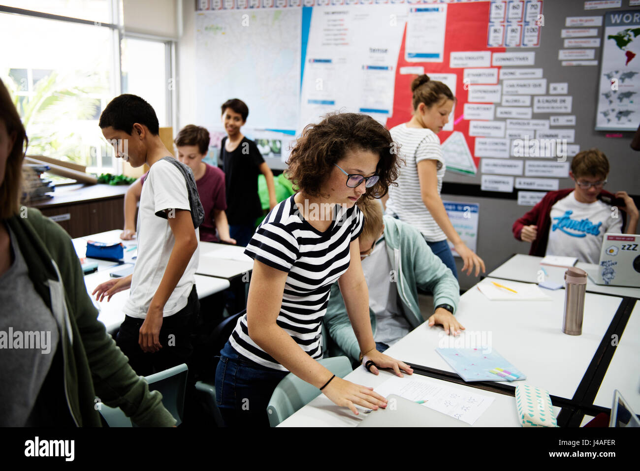Group of students learning in classroom Stock Photo - Alamy