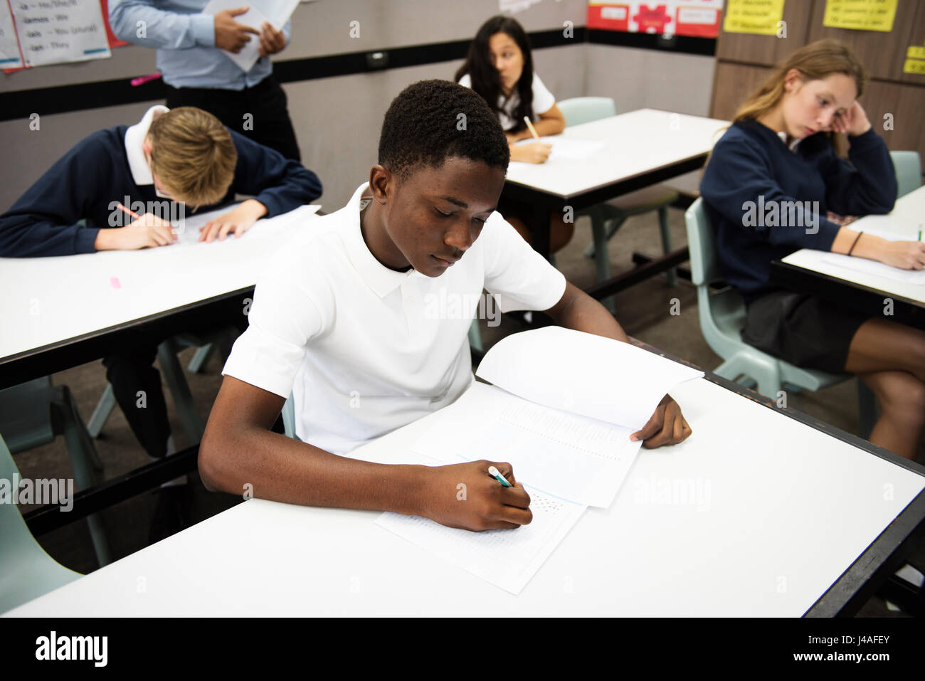 Students doing the exam in classroom Stock Photo - Alamy