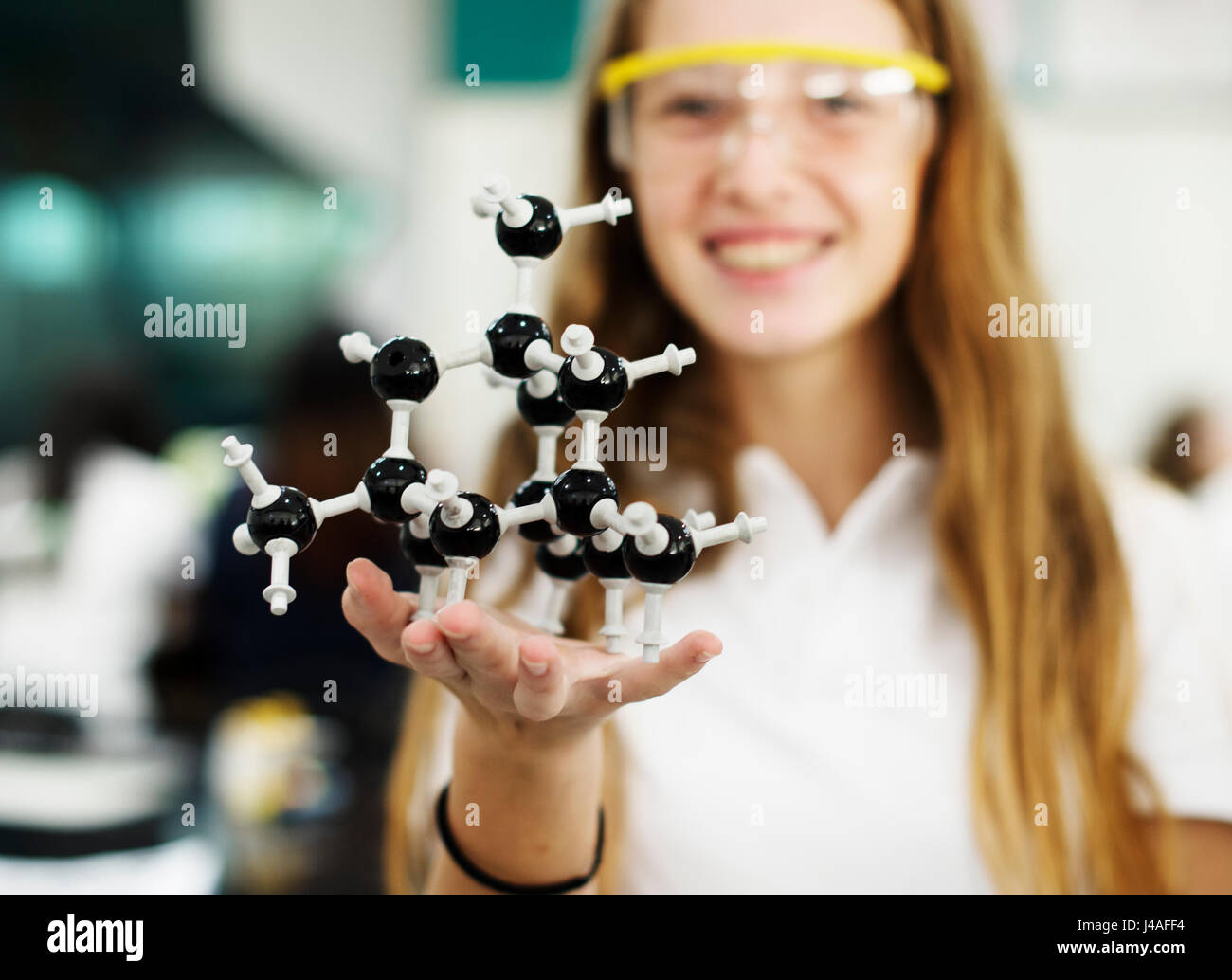 Student girl holding molecule on her hand Stock Photo - Alamy
