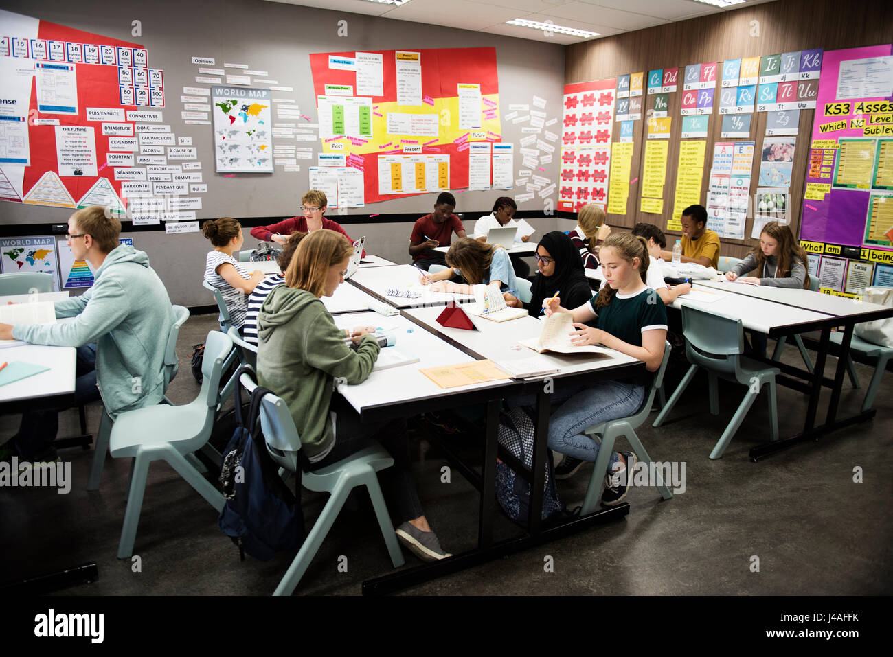 Group of students learning in classroom Stock Photo - Alamy