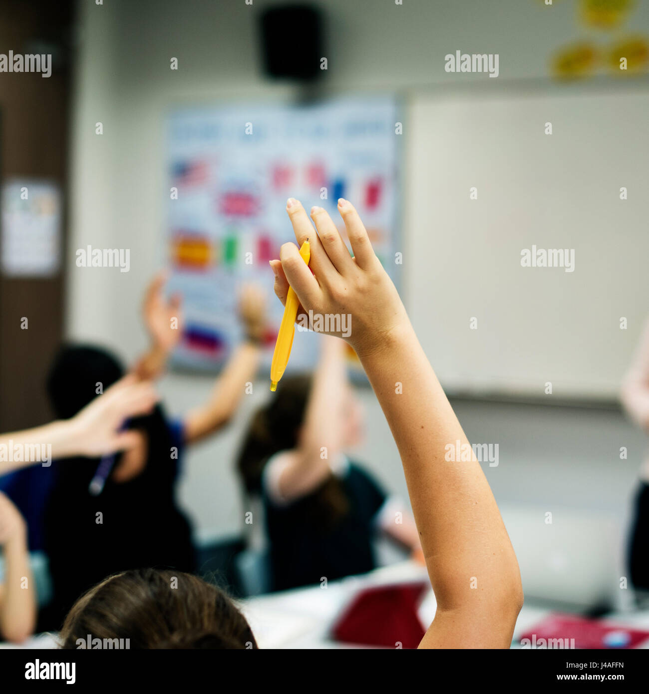 Group of student learning arms raised Stock Photo - Alamy