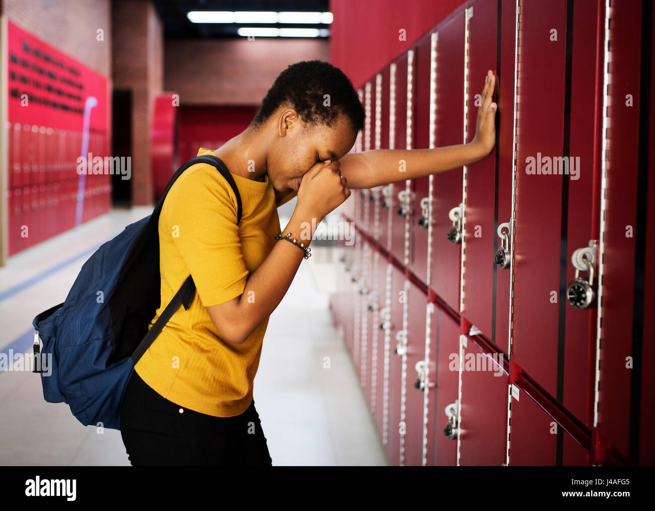Young sad student on the hallway Stock Photo - Alamy