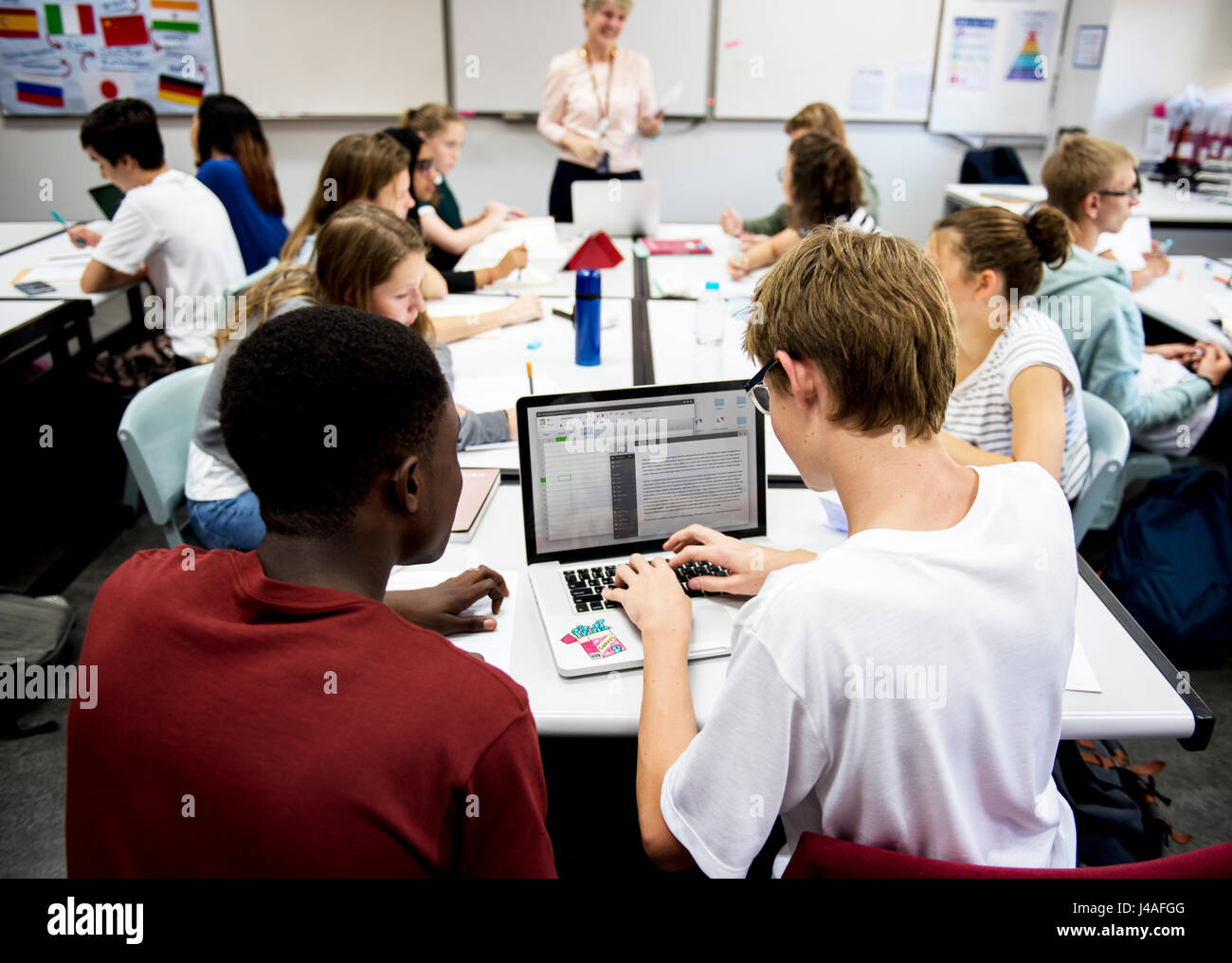 Group of students learning in classroom Stock Photo - Alamy