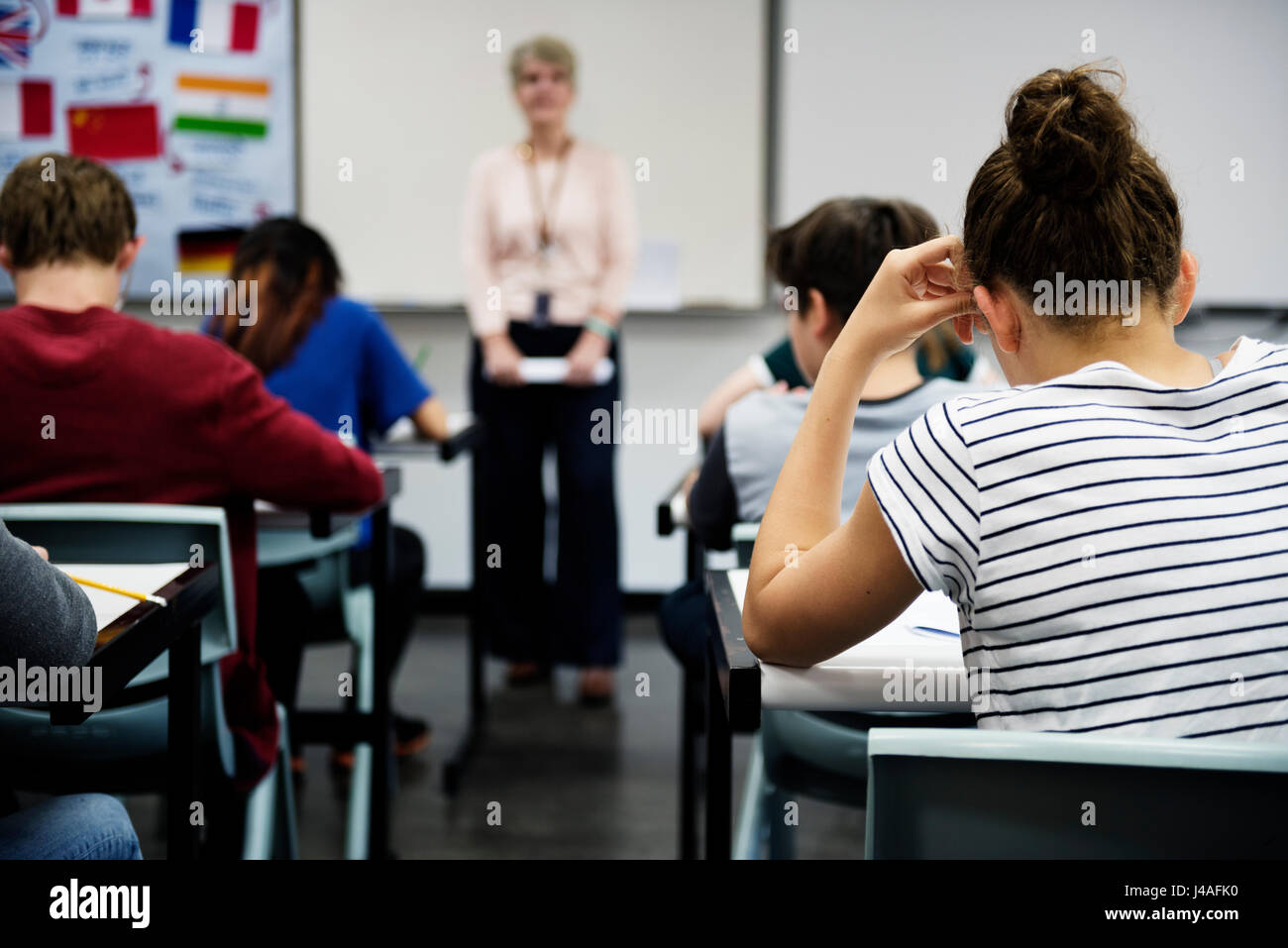 Students doing the exam in classroom Stock Photo - Alamy