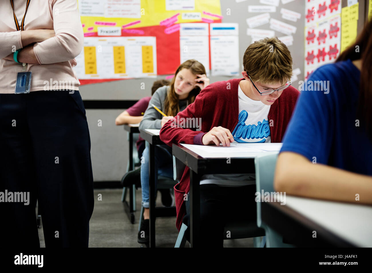 Students doing the exam in classroom Stock Photo - Alamy