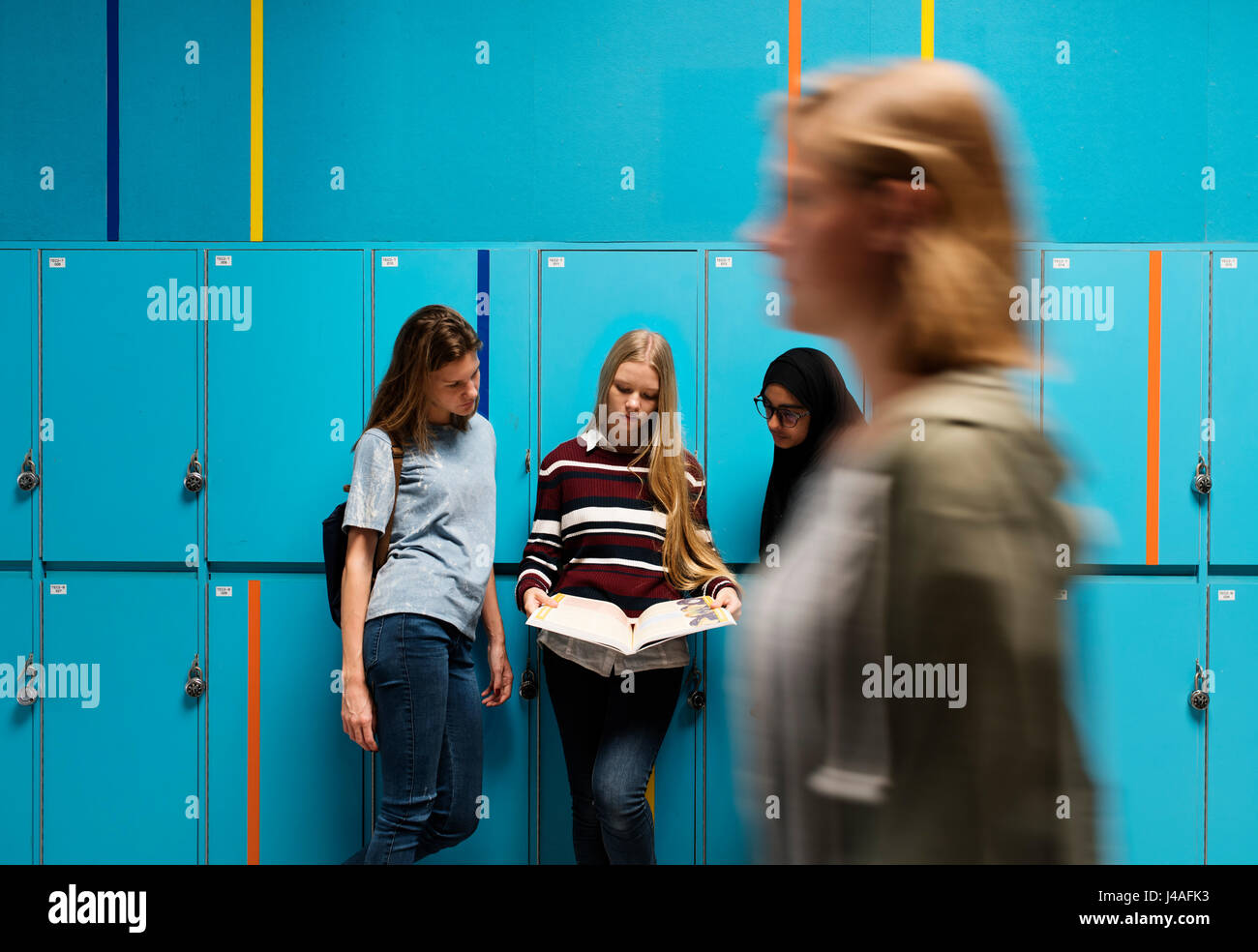 Students friends at lockers room Stock Photo - Alamy