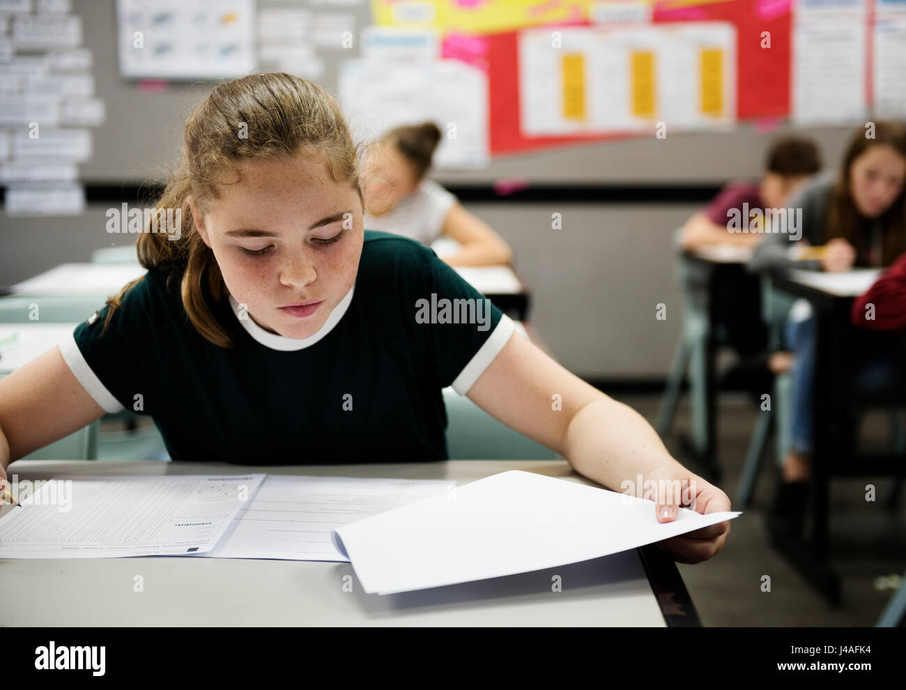 Students doing exam in classroom Stock Photo - Alamy