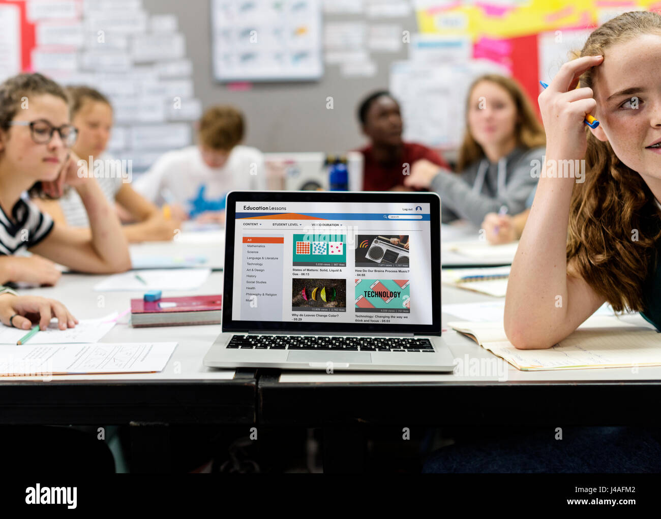 Group of students learning in classroom Stock Photo - Alamy