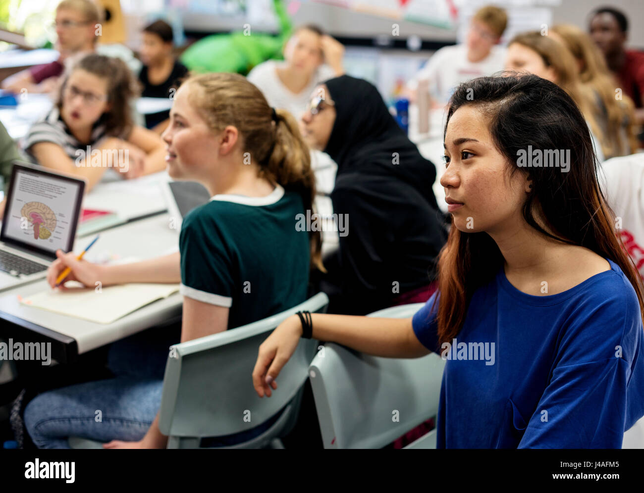 Group of students learning in classroom Stock Photo - Alamy