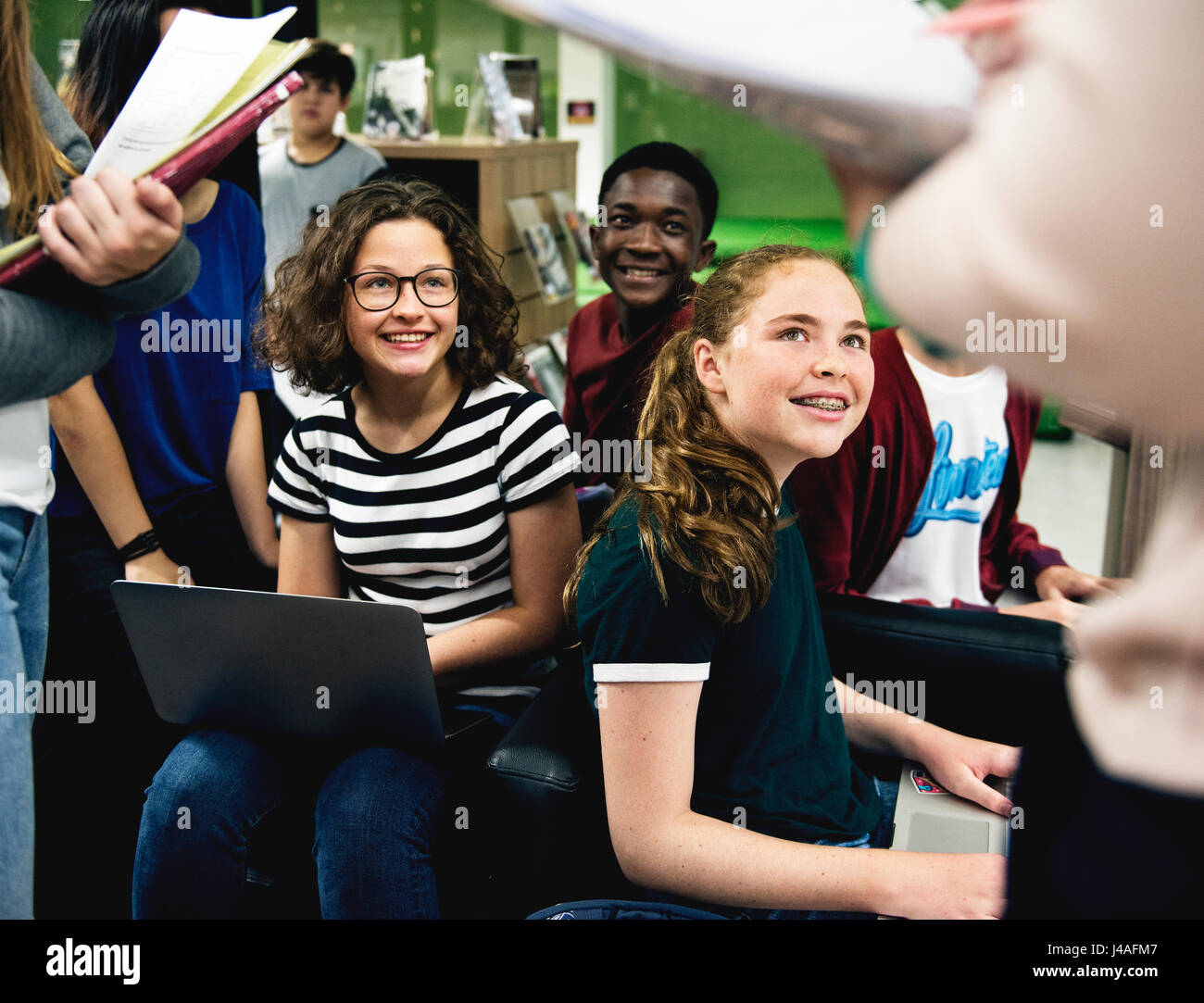 Group of students learning in classroom Stock Photo - Alamy