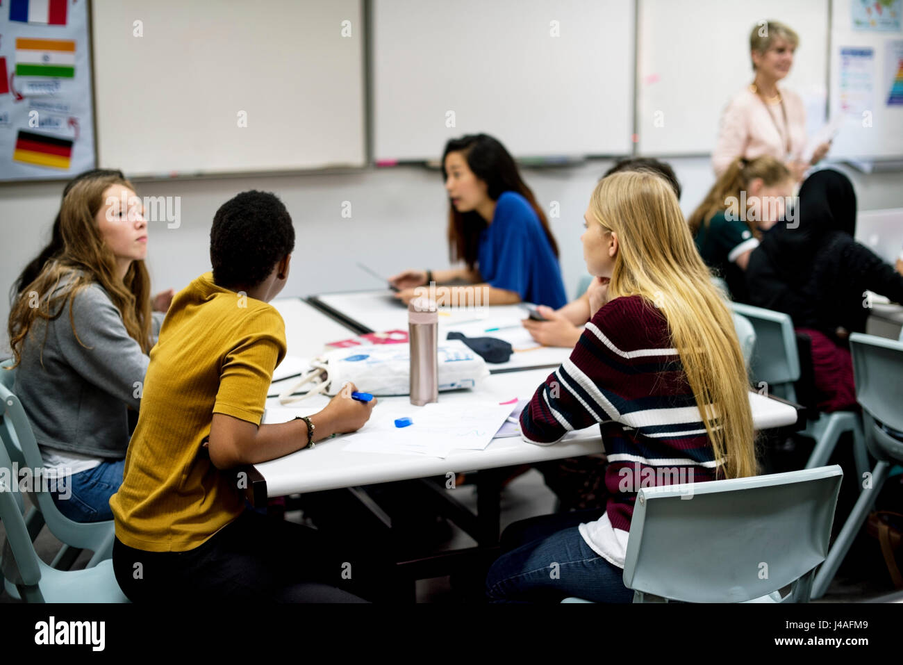Group of students learning in classroom Stock Photo - Alamy