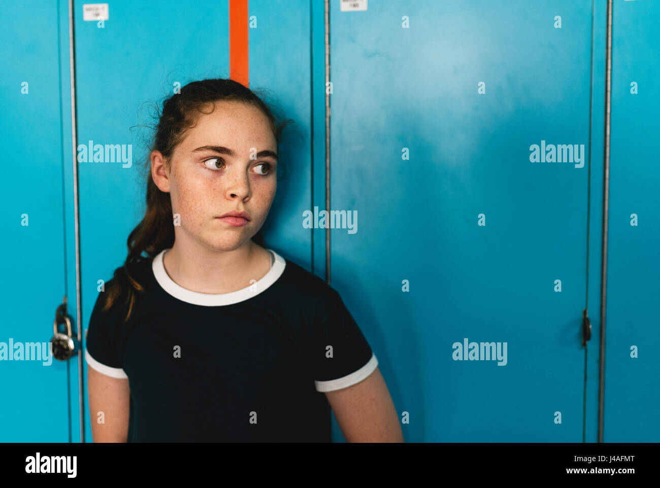 Student girl standing alone and staring Stock Photo - Alamy