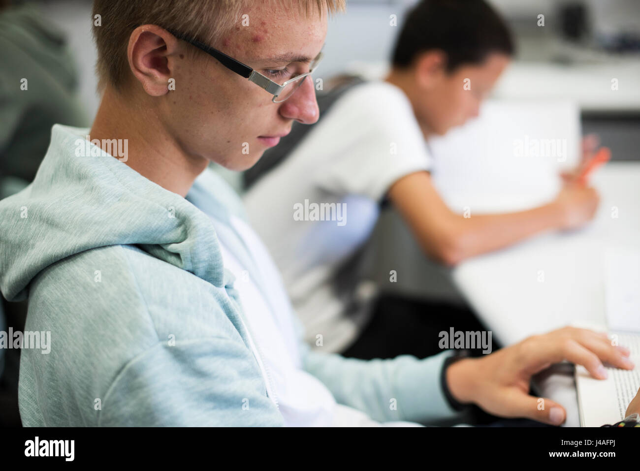 Students reading book at library Stock Photo - Alamy