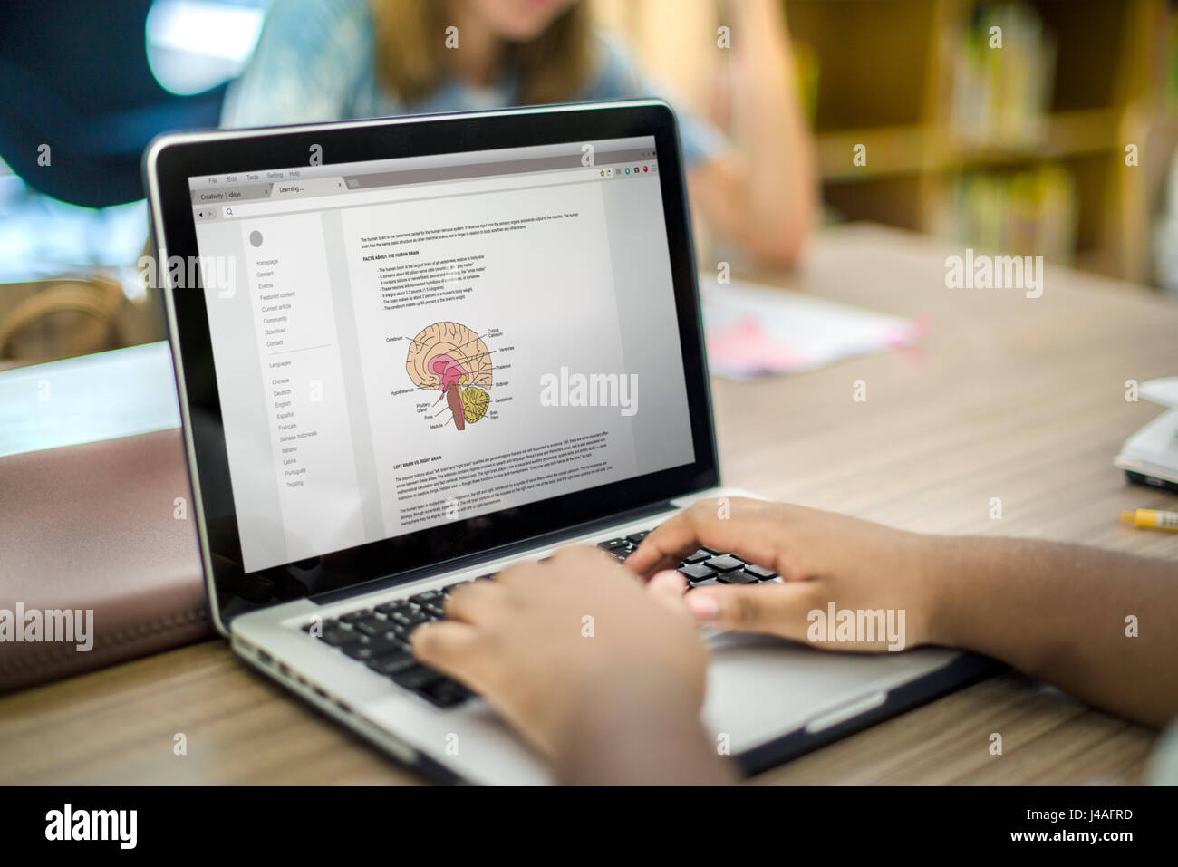 Hands using laptop about biology science in library Stock Photo - Alamy