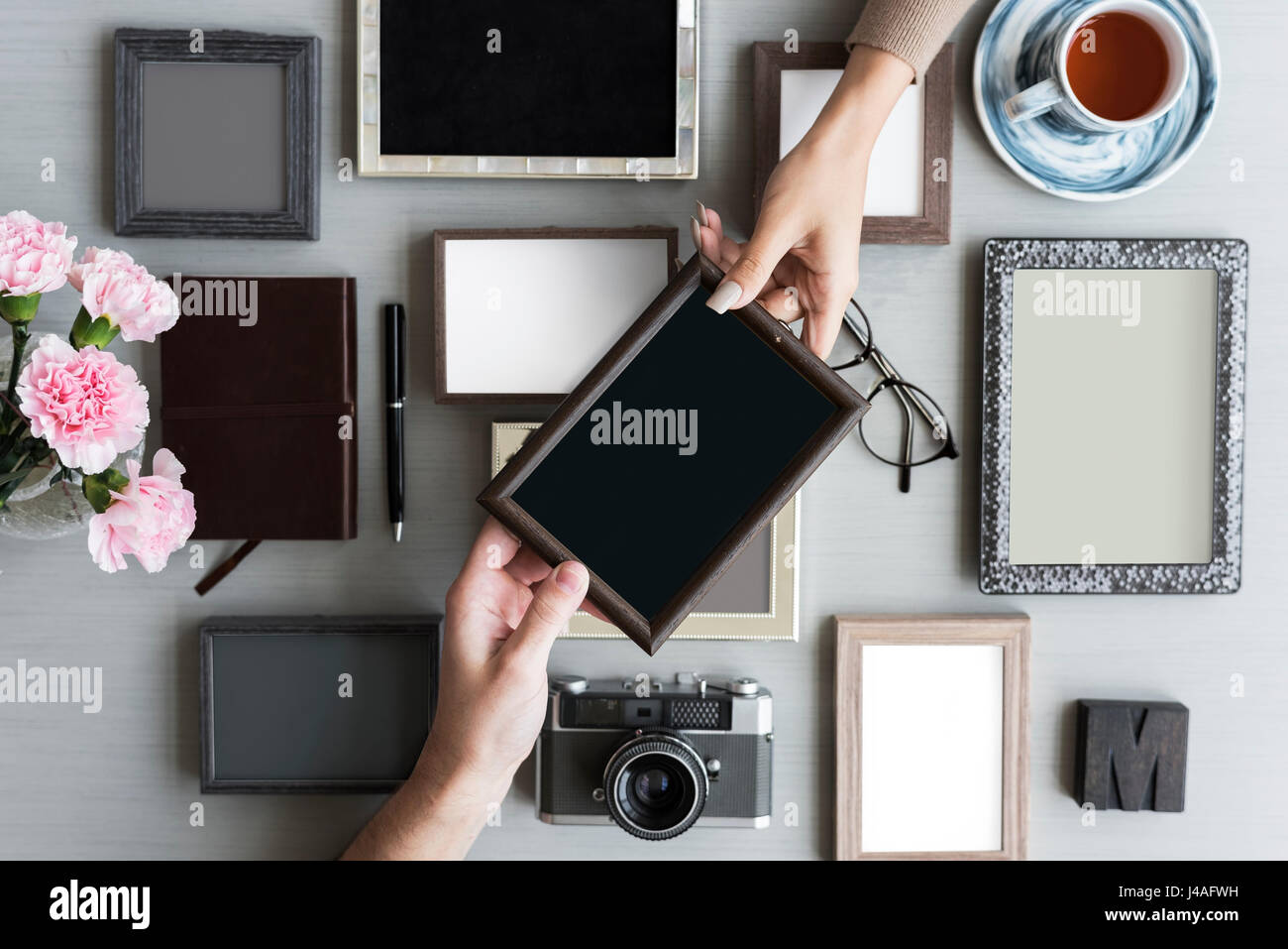 People Hands Getting Photo Frame on Gray Background Stock Photo - Alamy