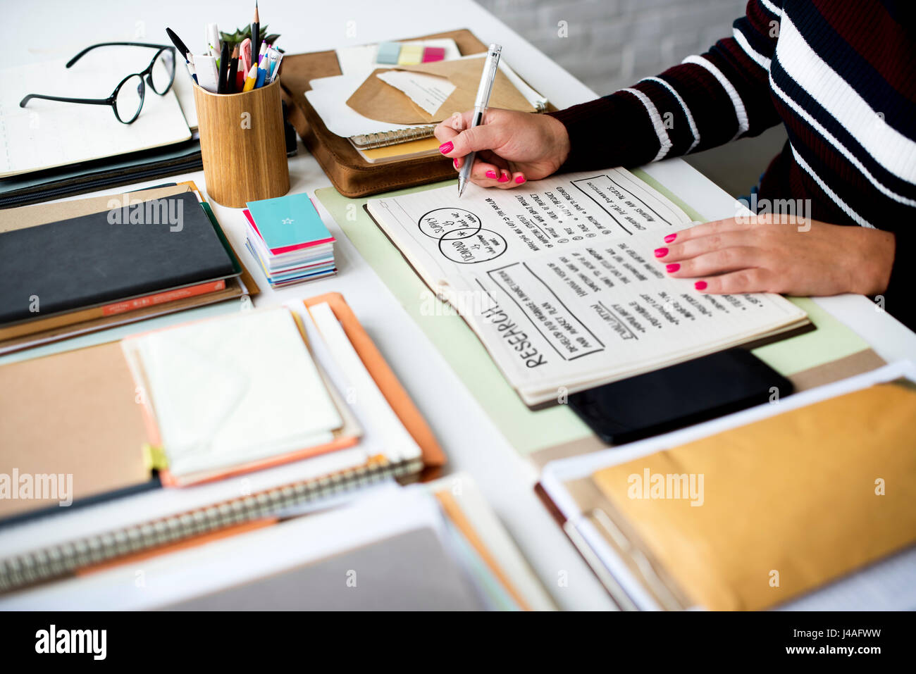 Hands Working on Office Desk with Notebooks and Stationery on White ...