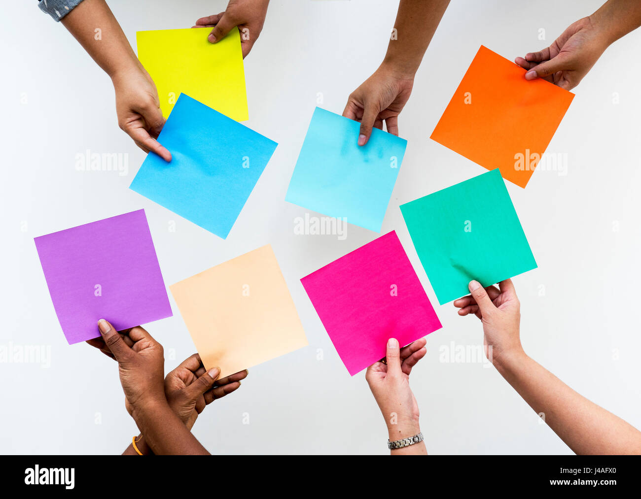 Hands Holding Multi Colors of Papers on White Background Stock Photo ...