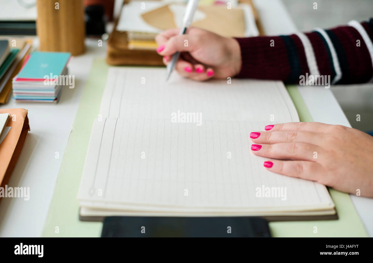 Woman hand holding pen work on blank notepad page Stock Photo - Alamy