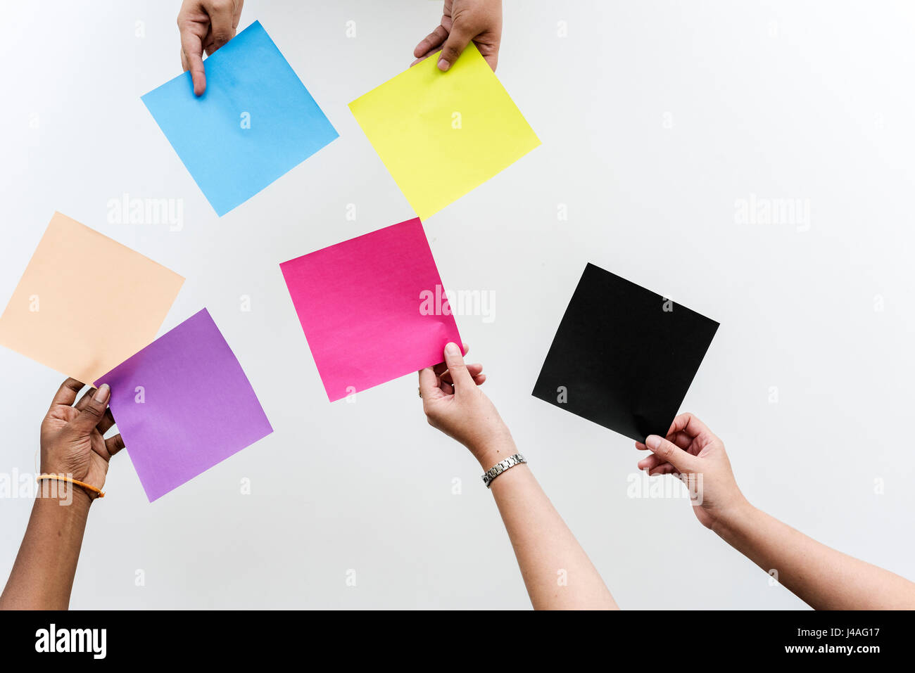 Hands Holding Multi Colors of Papers on White Background Stock Photo ...