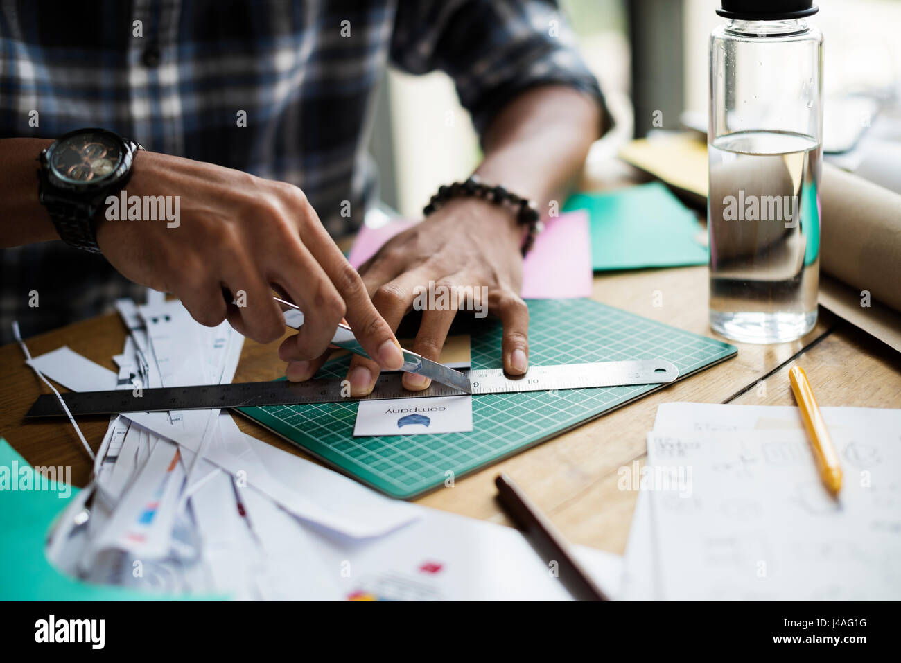 Hands Holding Cutter Cutting Paper Stock Photo - Alamy
