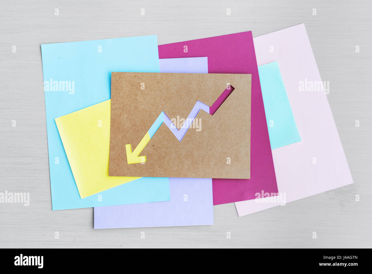 Down Arrow Graph on Brown Paper Stock Photo - Alamy