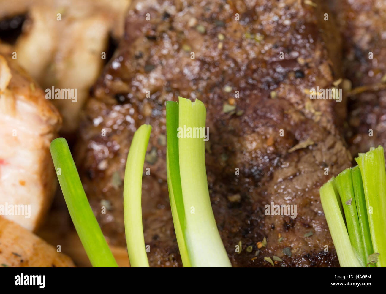 Mixed grilled meats platter with vegetables and sauces. Macro. Photo ...