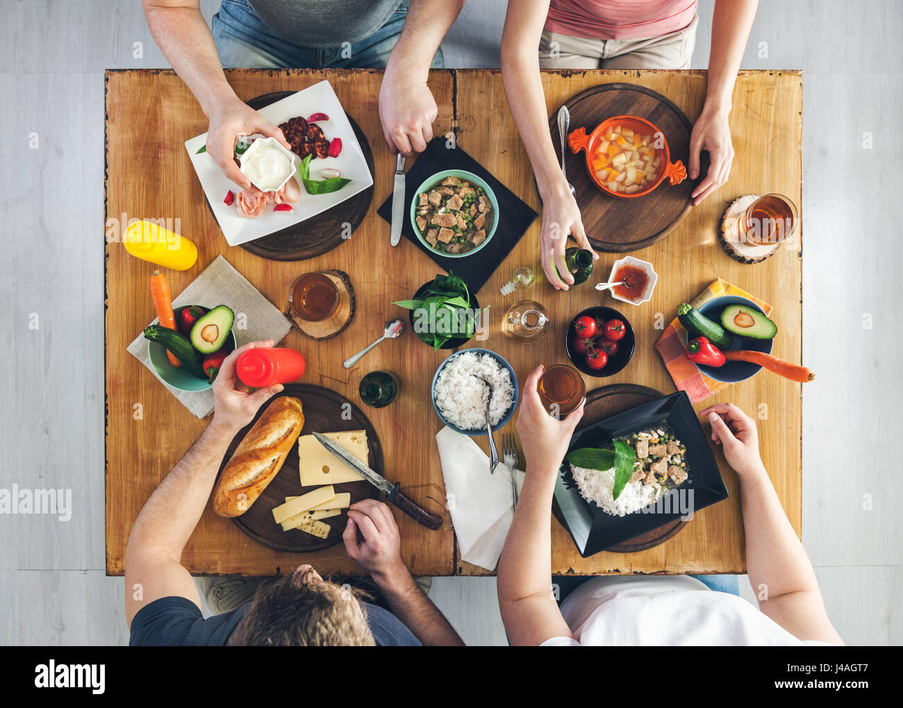 Top view, Group of people sitting at the wooden table having meal Stock ...