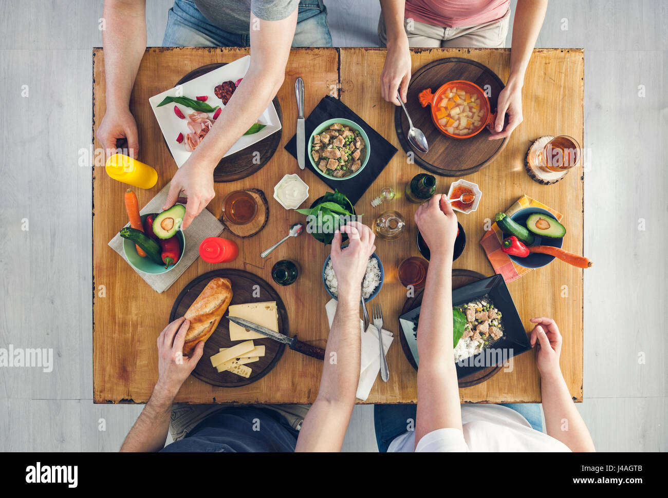 Top view, Group of people sitting at the wooden table having meal Stock ...