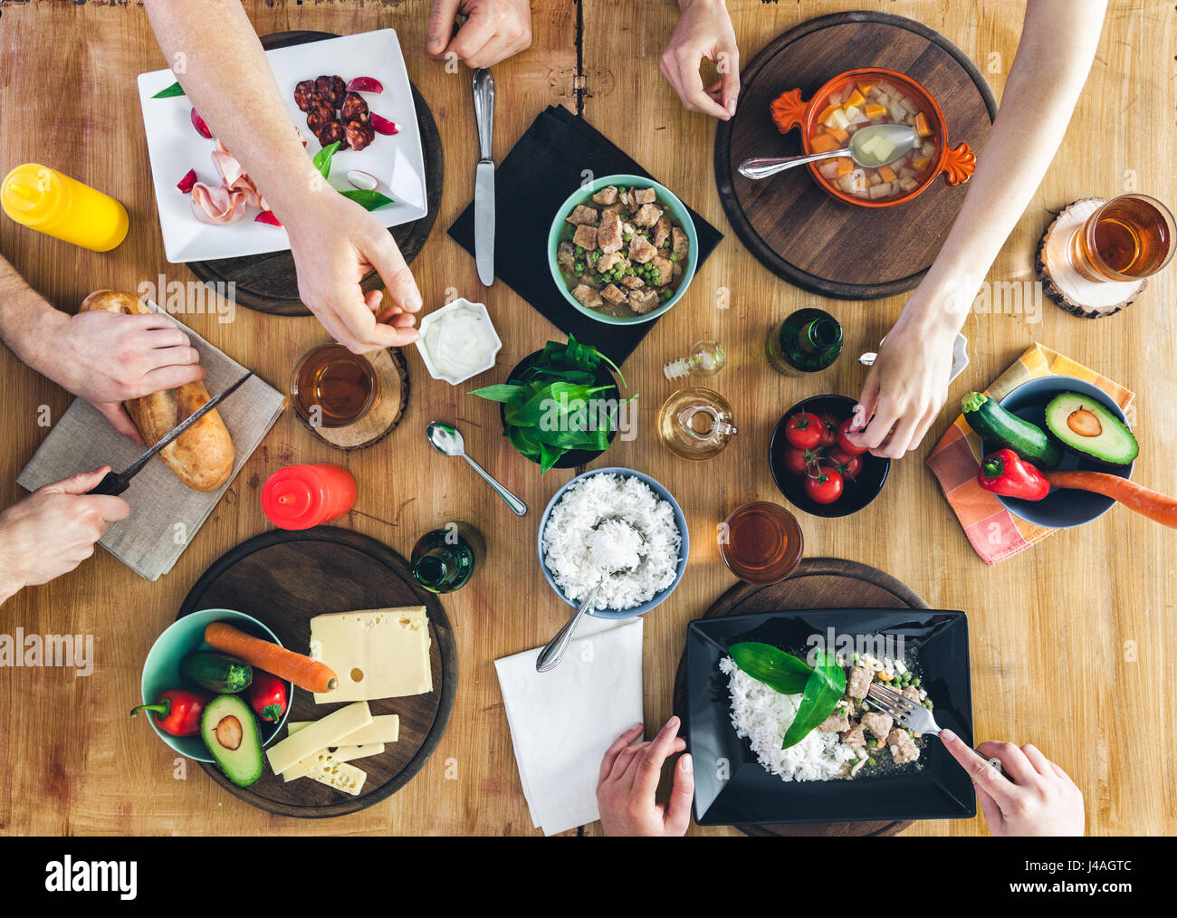 Top view, Group of people sitting at the wooden table having meal Stock ...