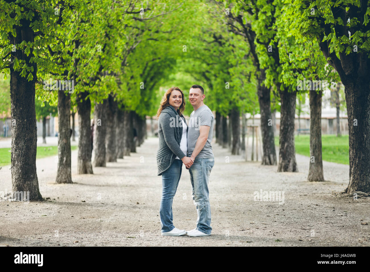 Young happy loving couple outdoors in a park Stock Photo - Alamy