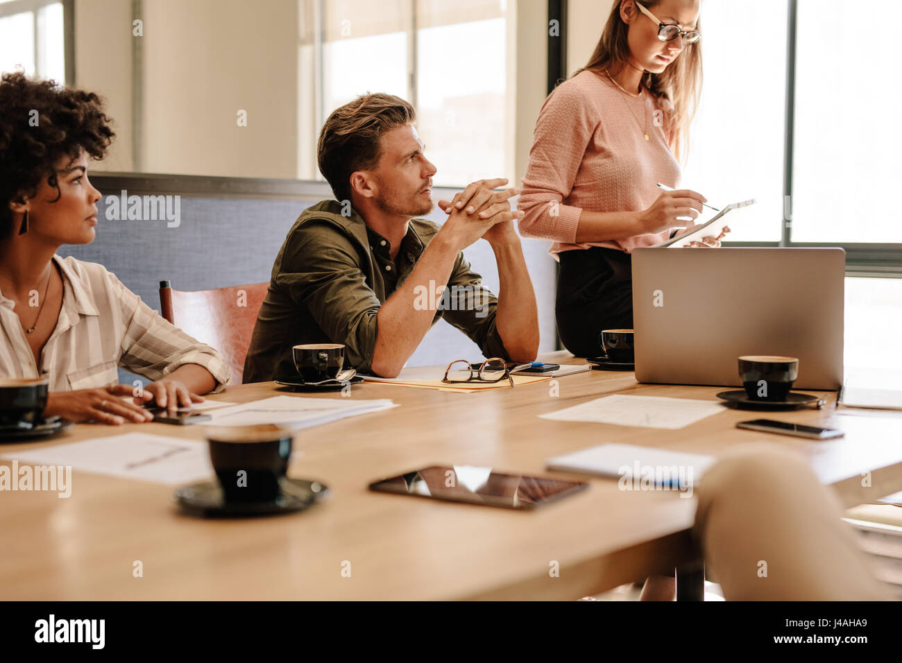 Young businessman listening to his colleague during a meeting ...